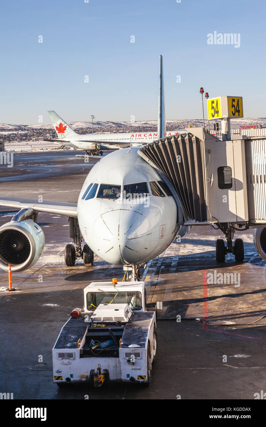 CALGARY, CANADA - DEC. 4, 2014: An Air Canada plane connected to a jet ...