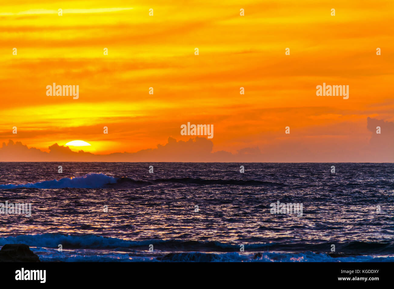 Orange sky over the sea at sunset Stock Photo - Alamy