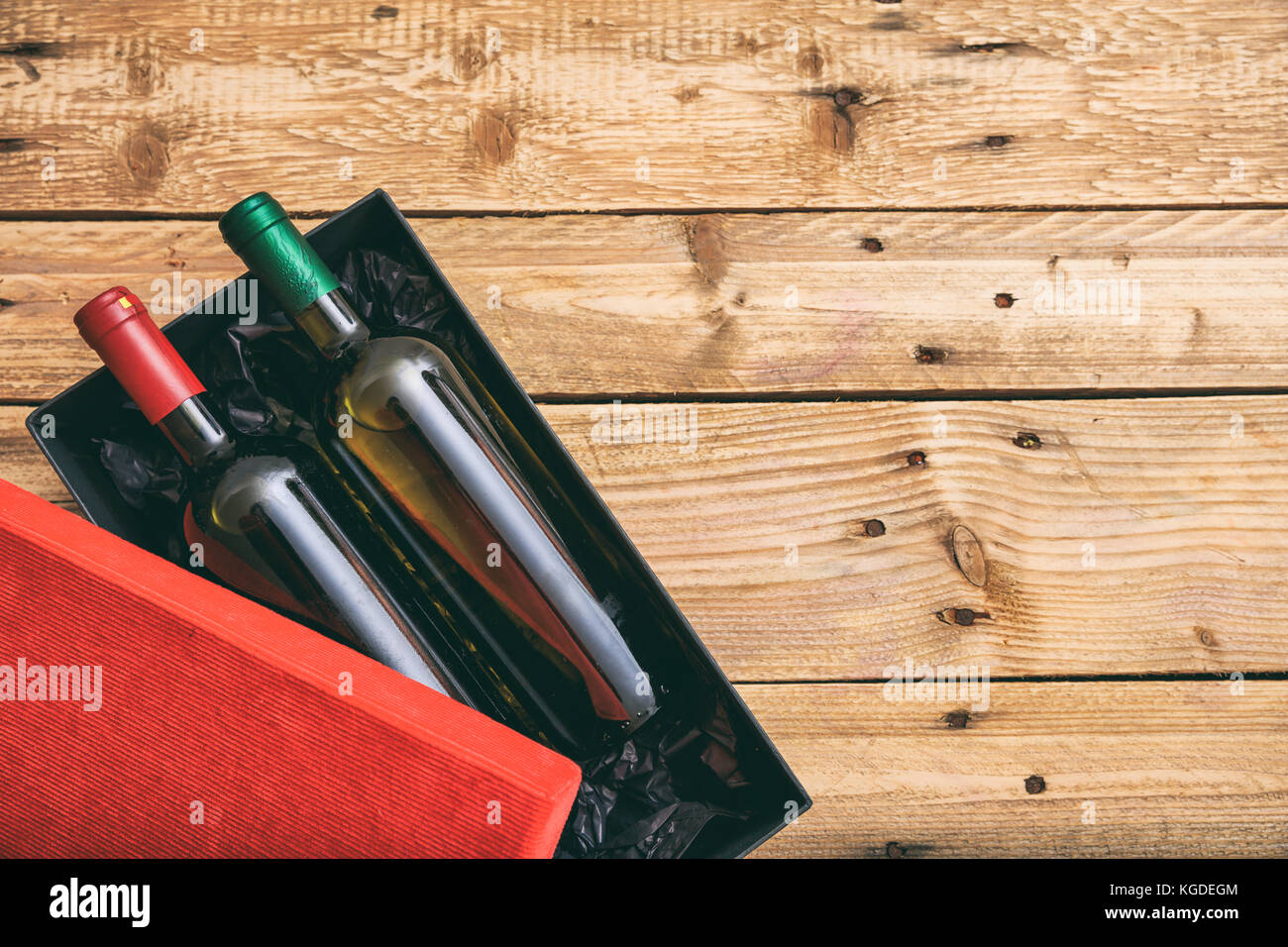Red and white wine bottles on wooden background, copy space, top view ...