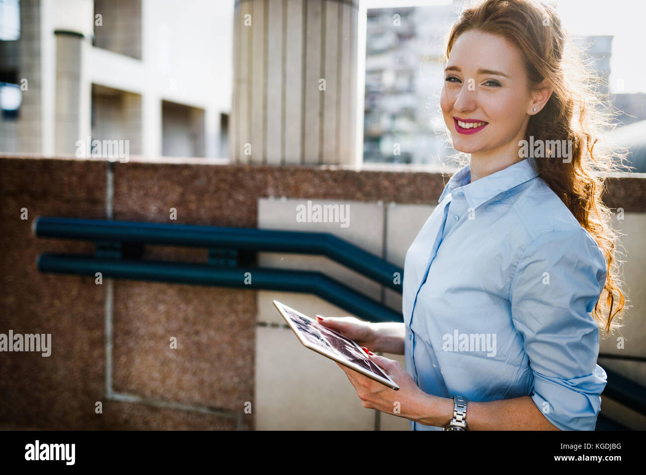 Portrait of businesswoman walking and holding tablet Stock Photo - Alamy