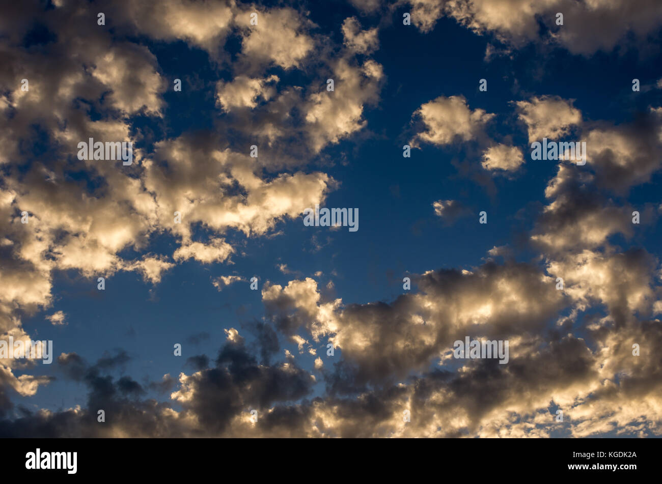 Dramatic sunset sky with golden clouds after thunderstorm Stock Photo ...