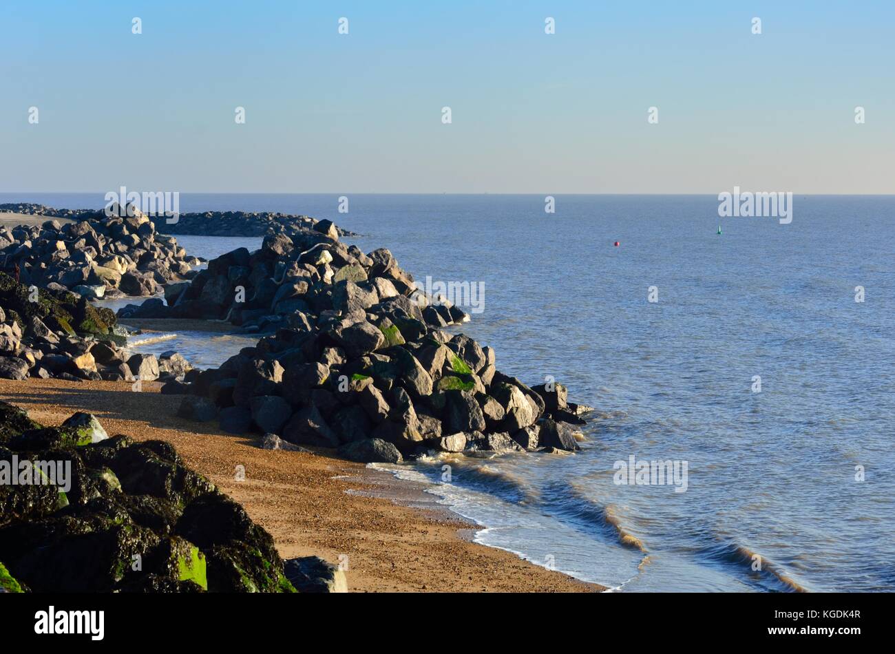 rocks stretching into sea Stock Photo - Alamy