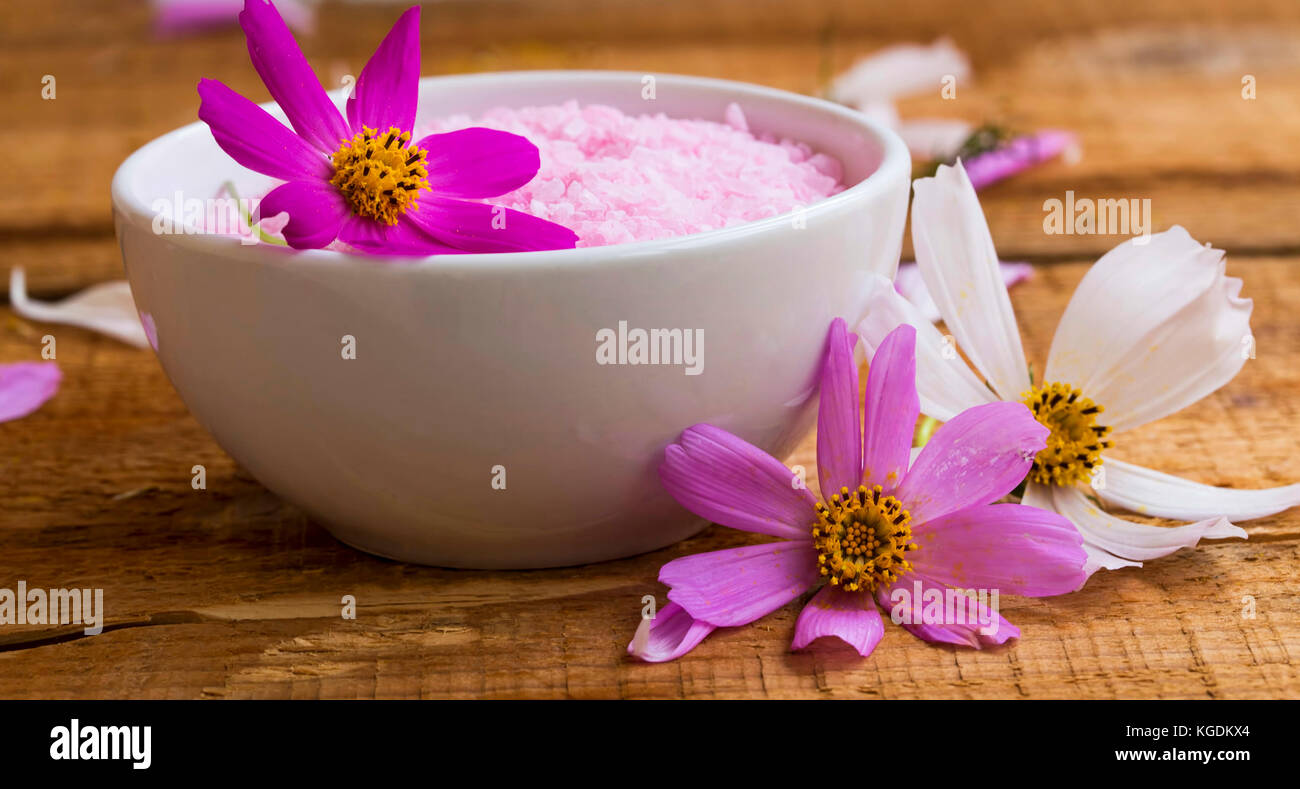 Spa setting with bath salt, floral bath salt bowl on wooden table ...