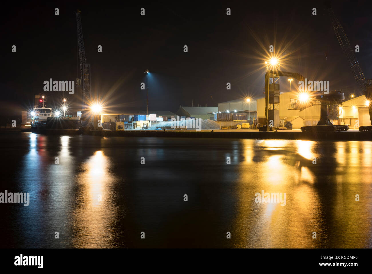 Poole docks at night lit up with colourful lights refelecting in the ...