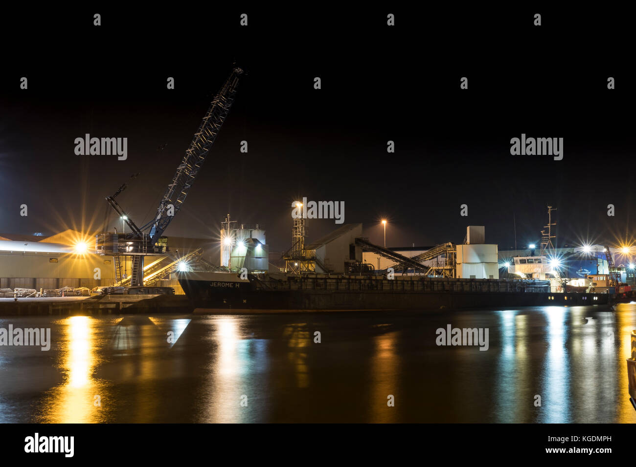 Poole docks at night lit up with colourful lights refelecting in the ...