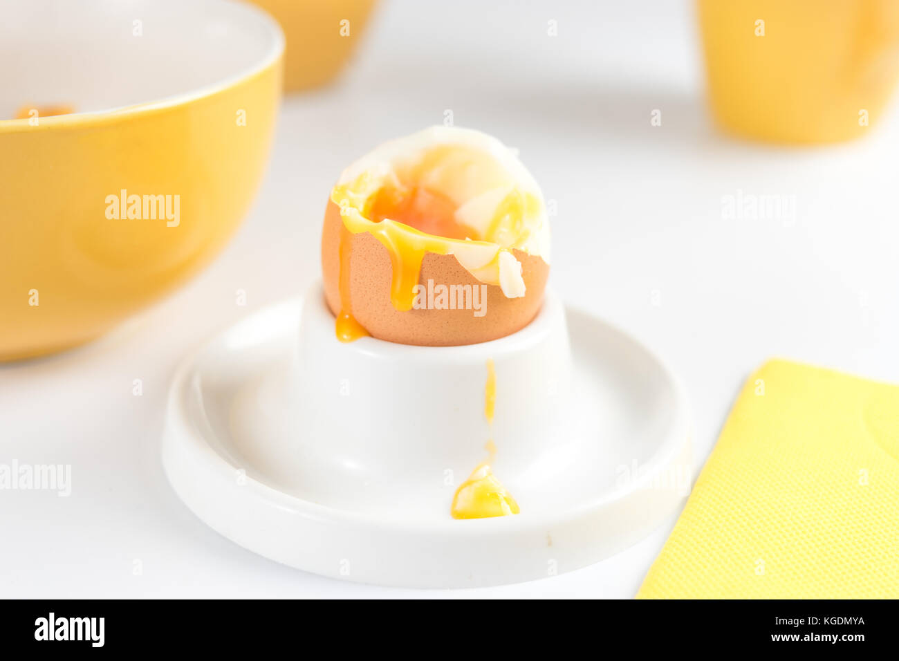 Close up of soft-boiled egg with cracked eggshell for breakfast next to ...