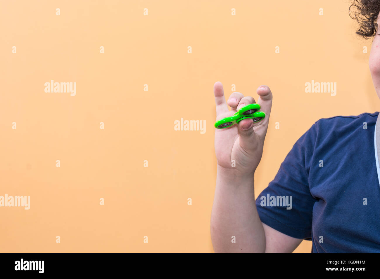 Boy playing with fidget spinner gadget. The fidget spinner is a toy, a ...