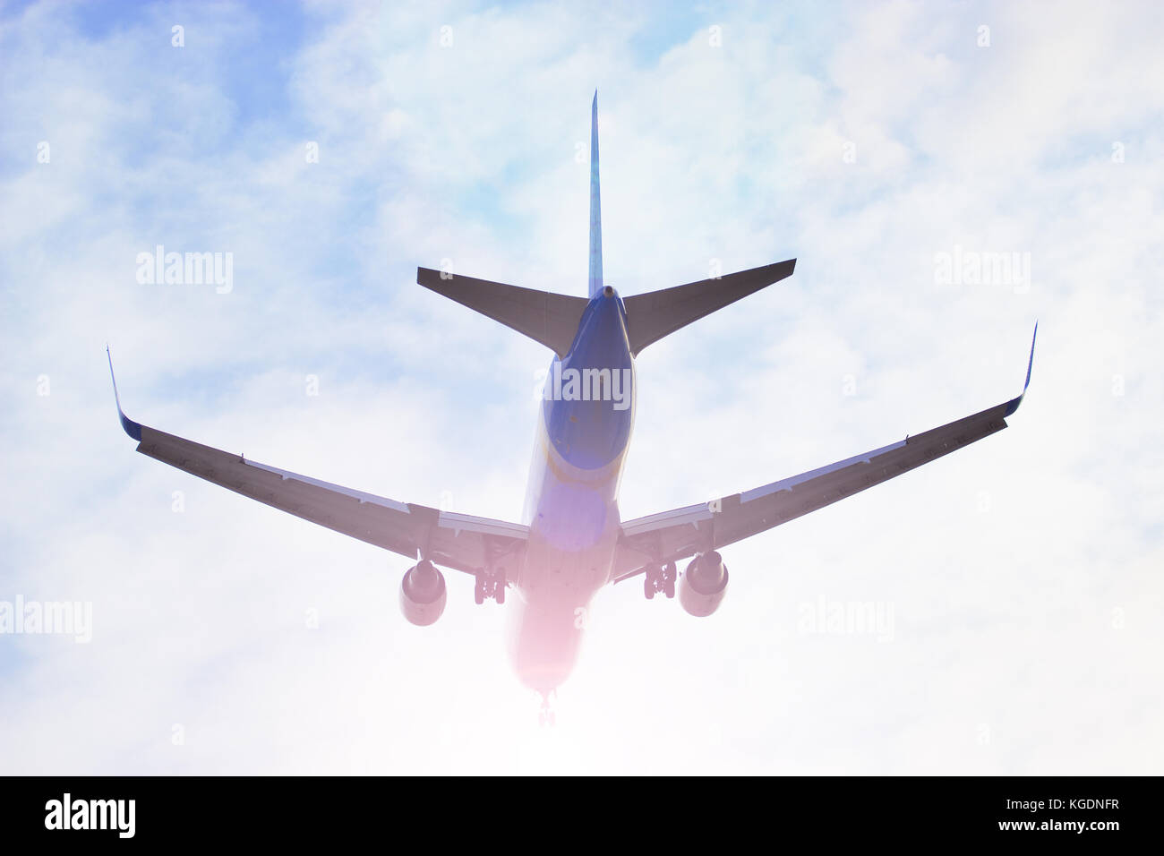 Plane flying through clouds in the sky. Jet aircraft in the air Stock ...