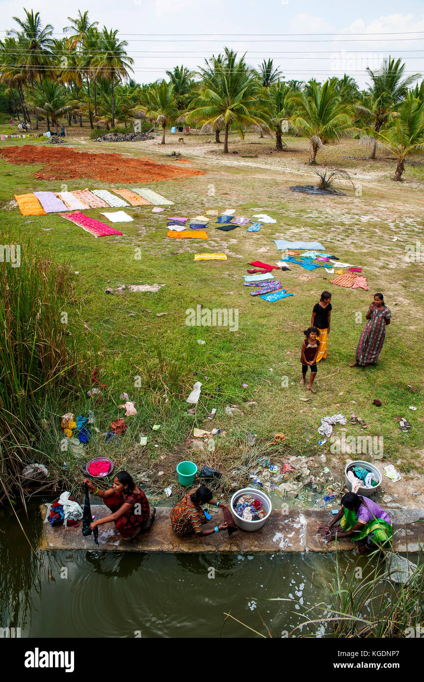 Indian woman washing clothes at a small pond, Karnataka, India Stock ...