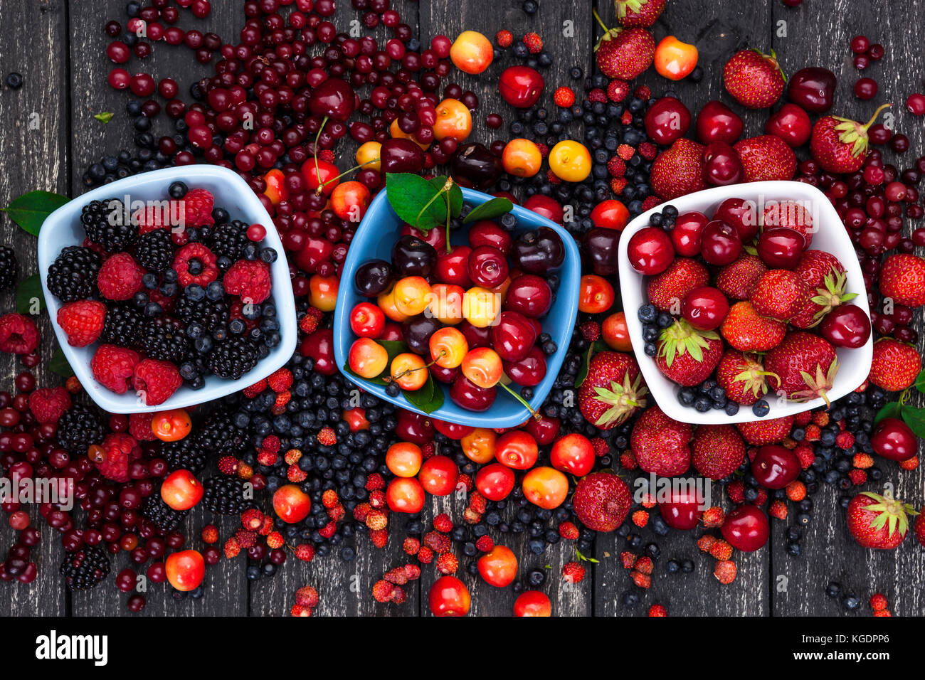 Fresh forest berries on wooden background. Top view Stock Photo - Alamy