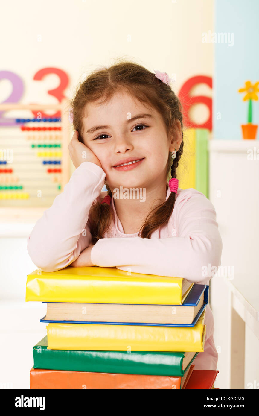 Preschool girl with a books Stock Photo - Alamy