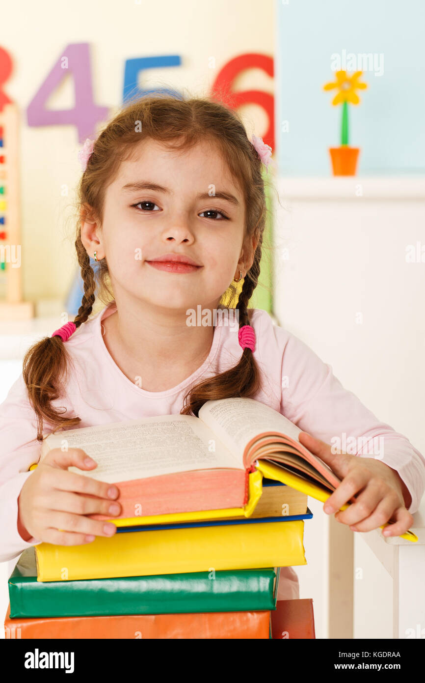 Preschool girl with a books Stock Photo - Alamy
