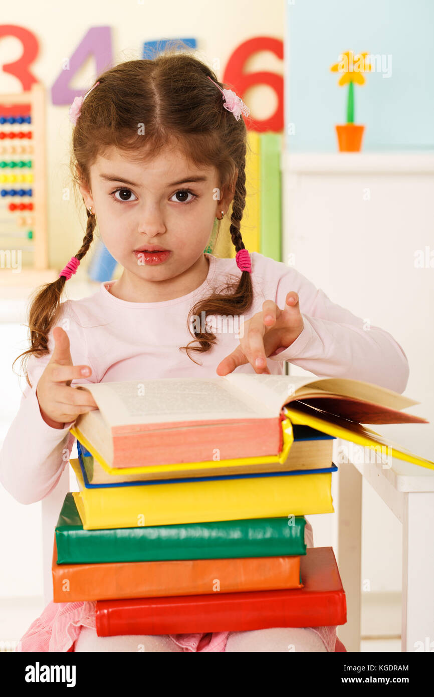 Preschool girl with a books Stock Photo - Alamy