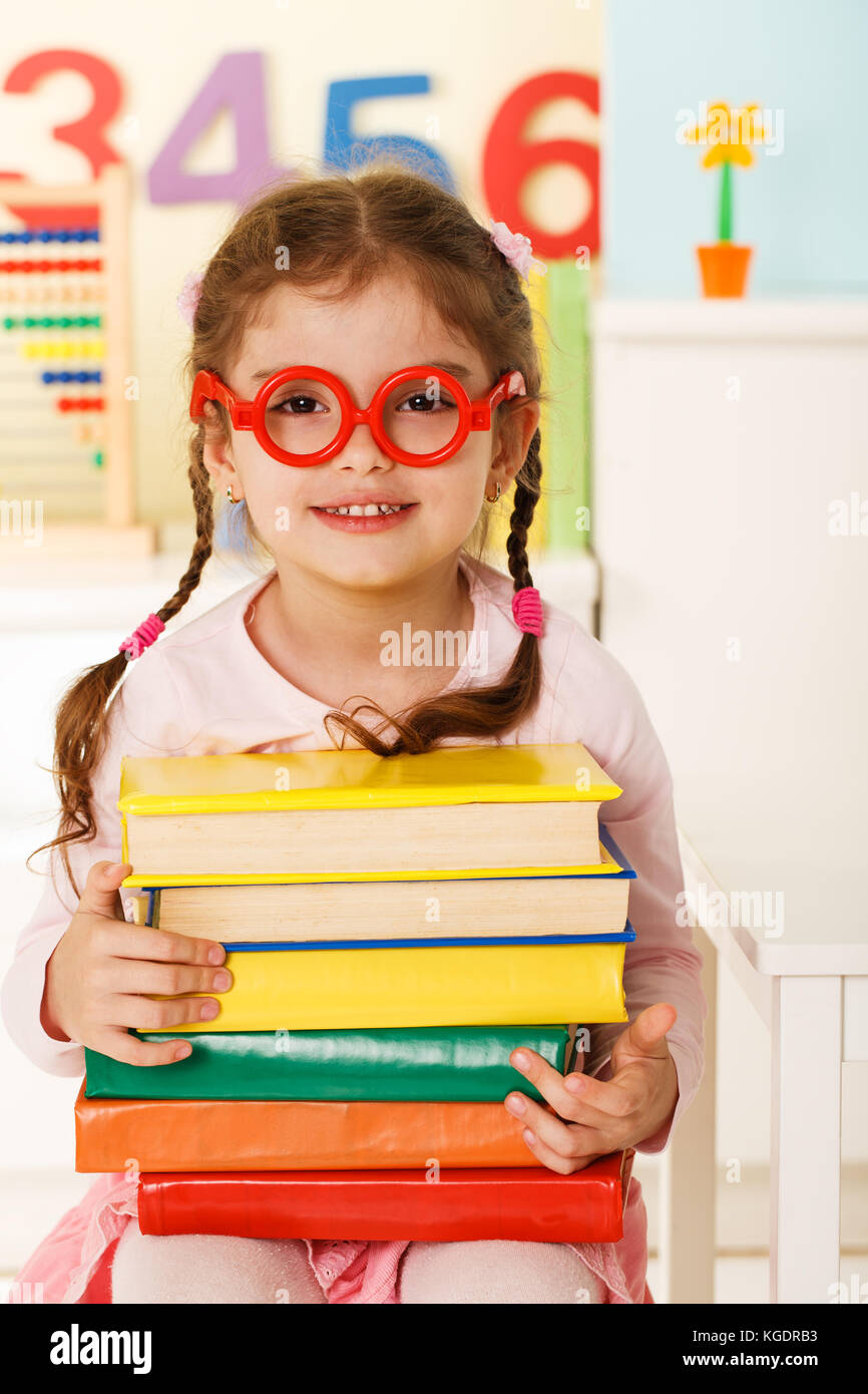 Preschool girl with a books Stock Photo - Alamy