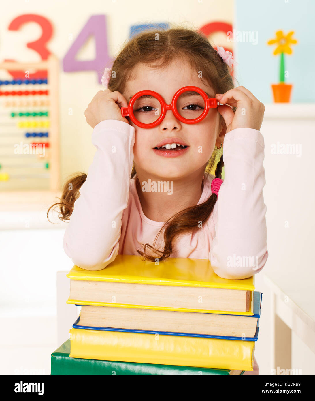 Preschool girl with a books Stock Photo - Alamy