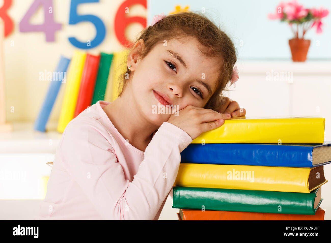 Preschool girl with a books Stock Photo - Alamy
