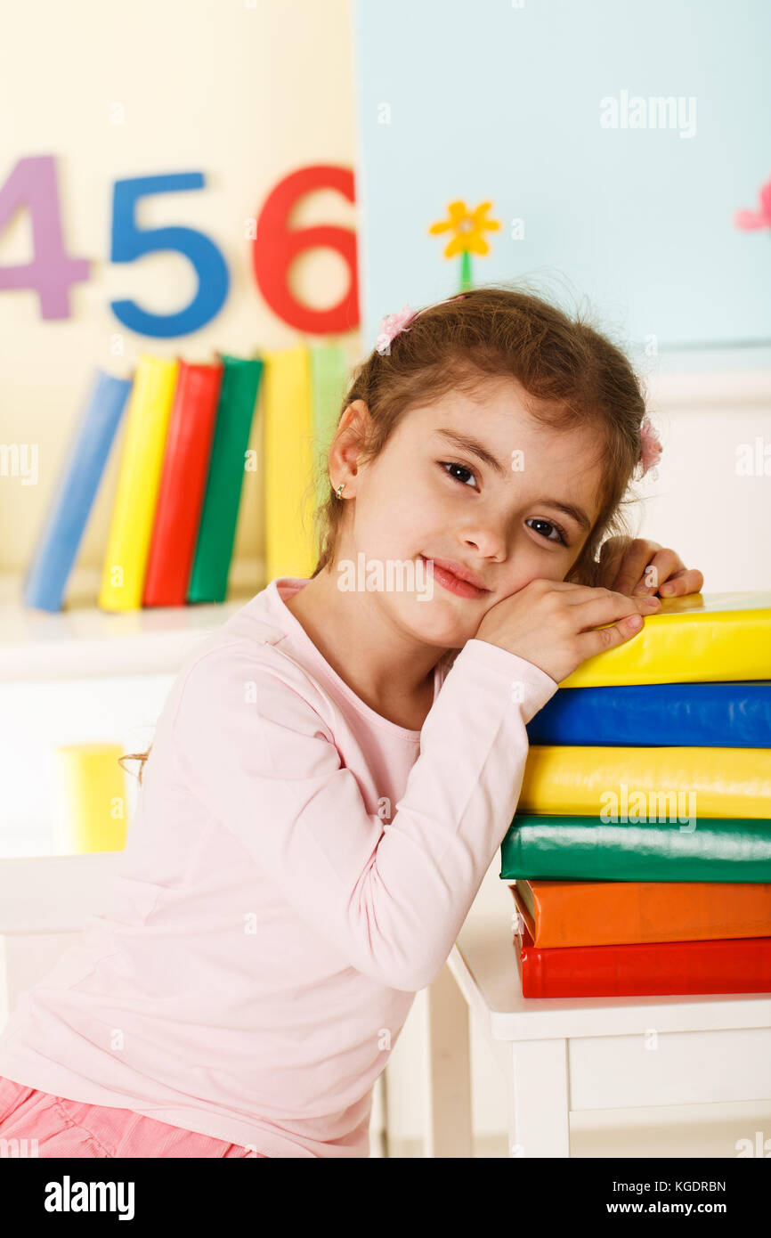 Preschool girl with a books Stock Photo - Alamy
