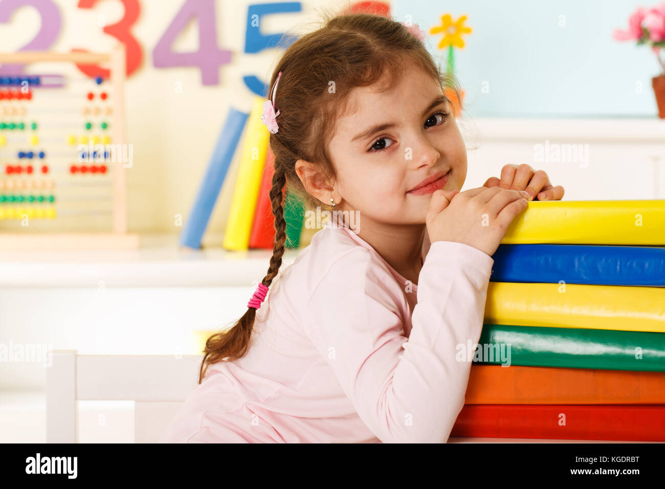 Preschool girl with a books Stock Photo - Alamy