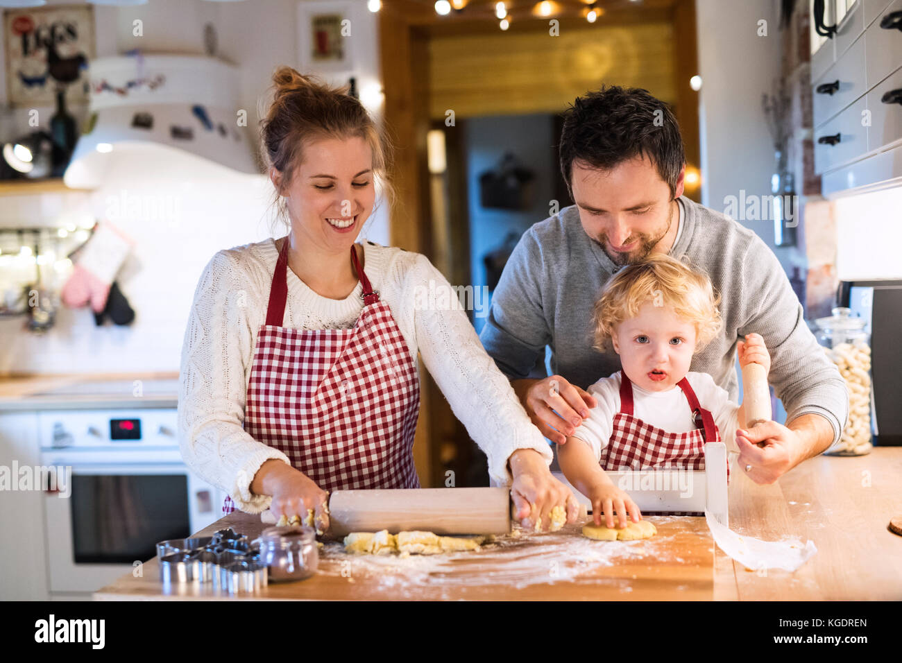 Young family making cookies at home Stock Photo - Alamy
