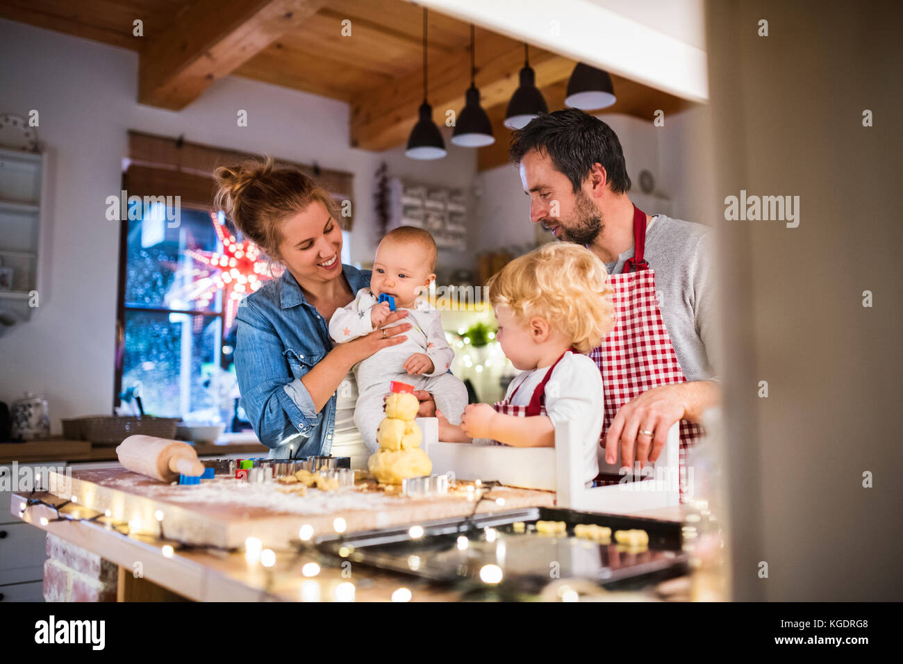 Young family making cookies at home Stock Photo - Alamy