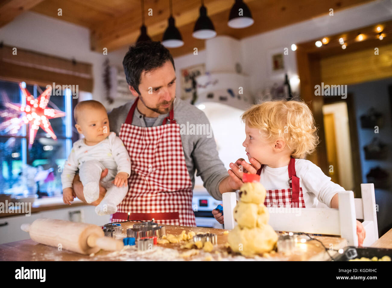 Young family making cookies at home Stock Photo - Alamy