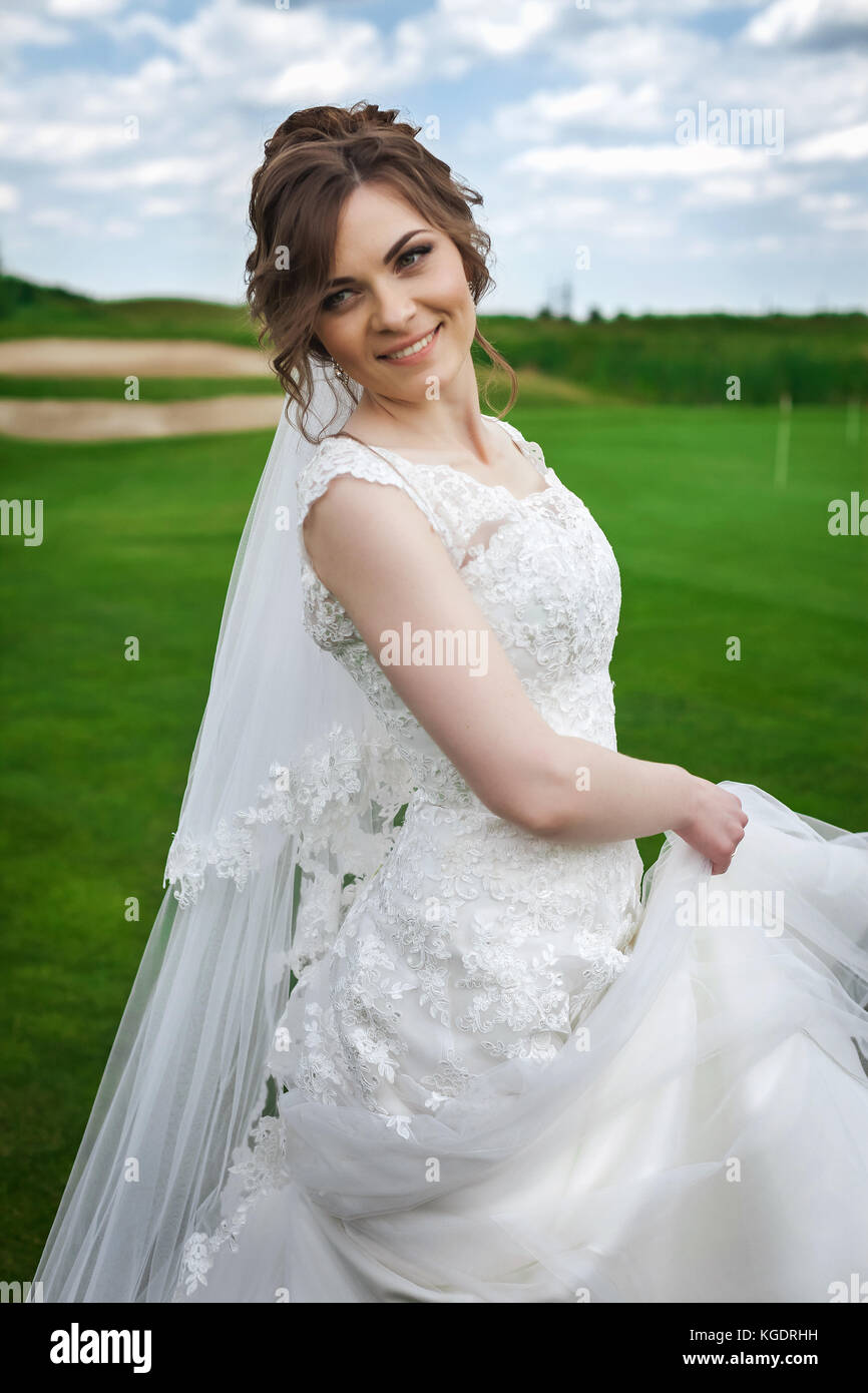 Attractive bride dancing on a meadow Stock Photo - Alamy