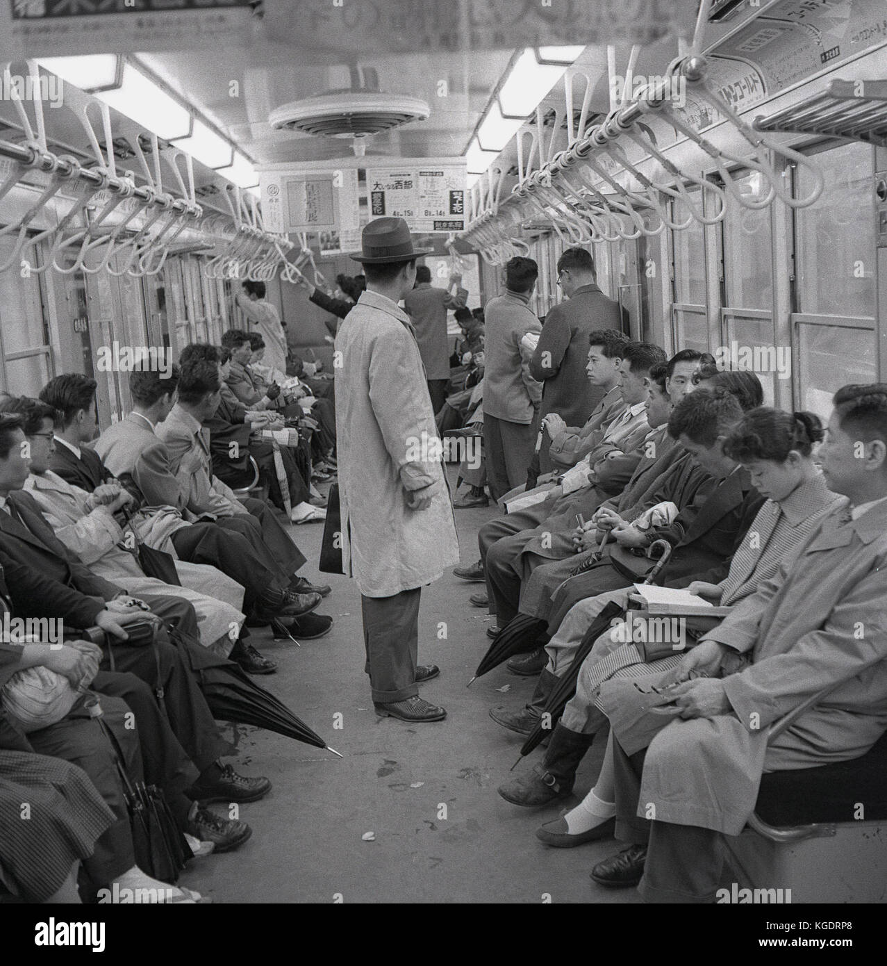 1950s, historical, Japanese commuters travelling on the rail subway ...