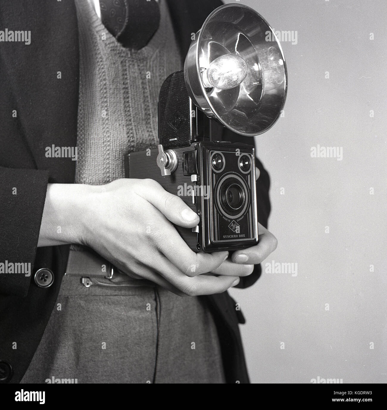 1950s, historical, young man holding an Agfax Synchro Box film camera ...