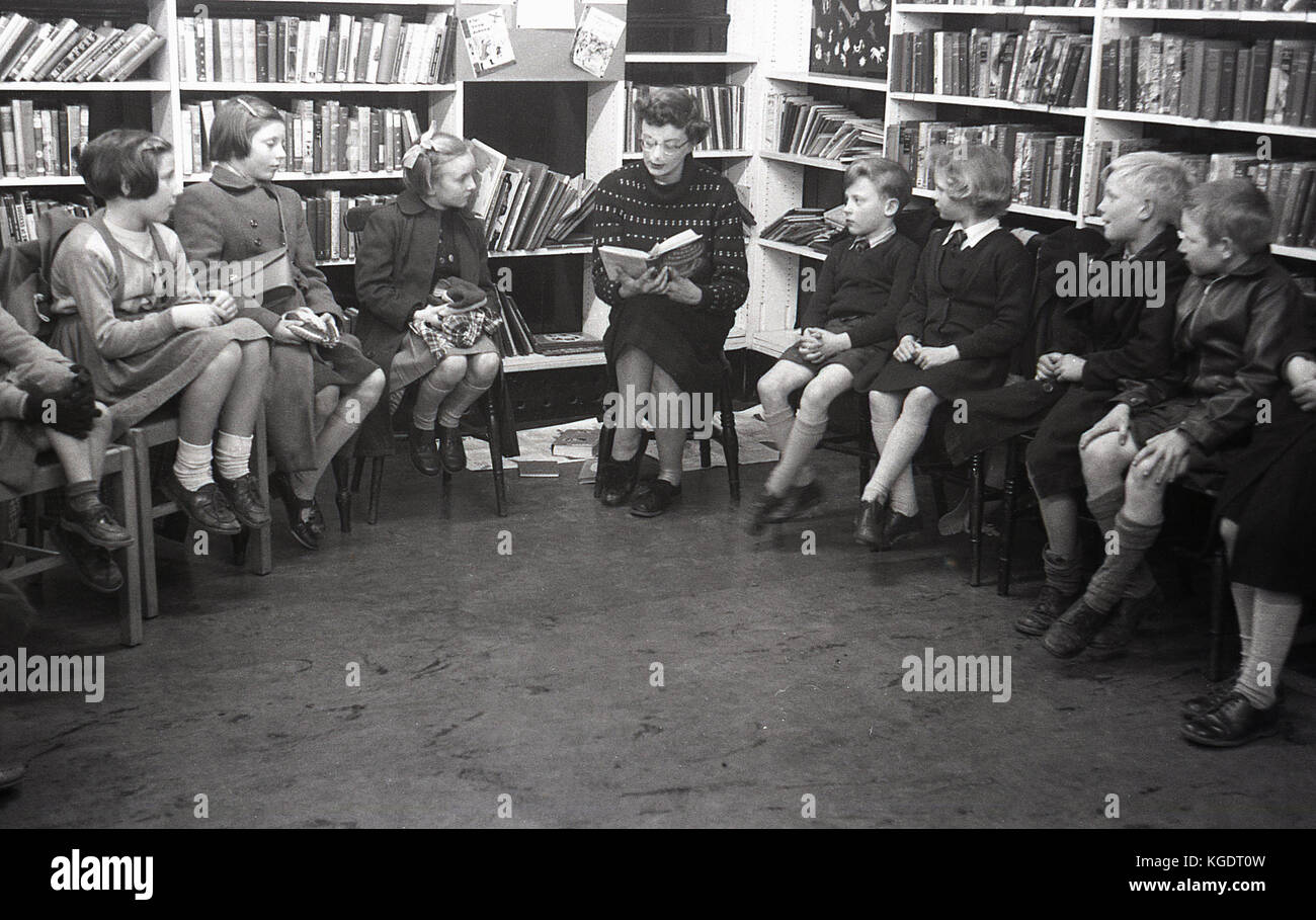 1950s, historical, storytime at school....picture shows a female ...