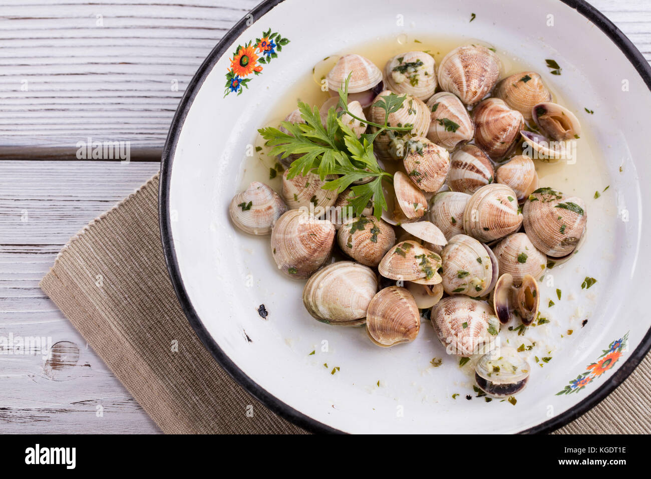 clams in very old plate with green parsley Stock Photo - Alamy