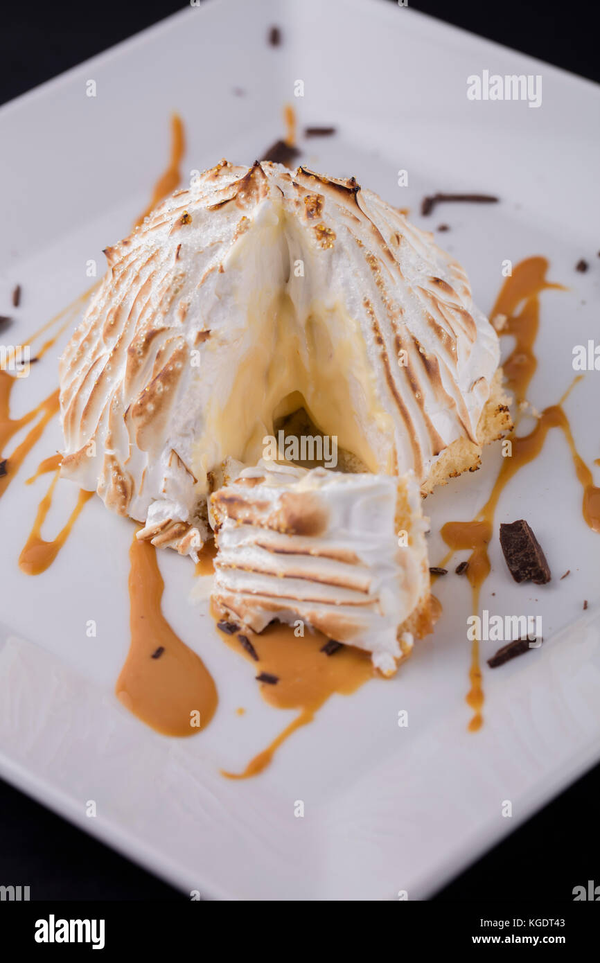 baked alaska desert on white plate Stock Photo - Alamy