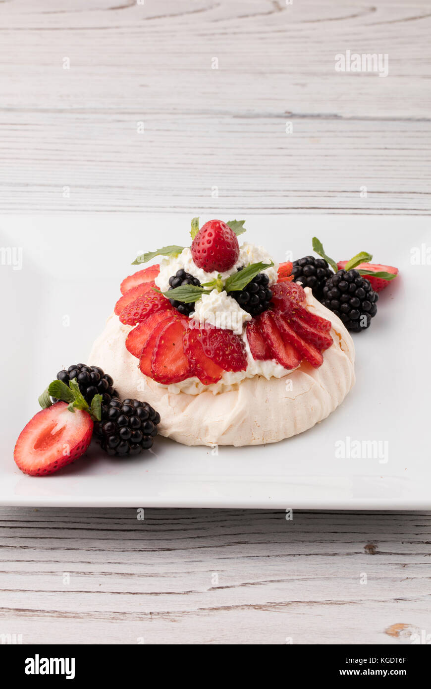 pavlova desert with cherry on white background Stock Photo - Alamy