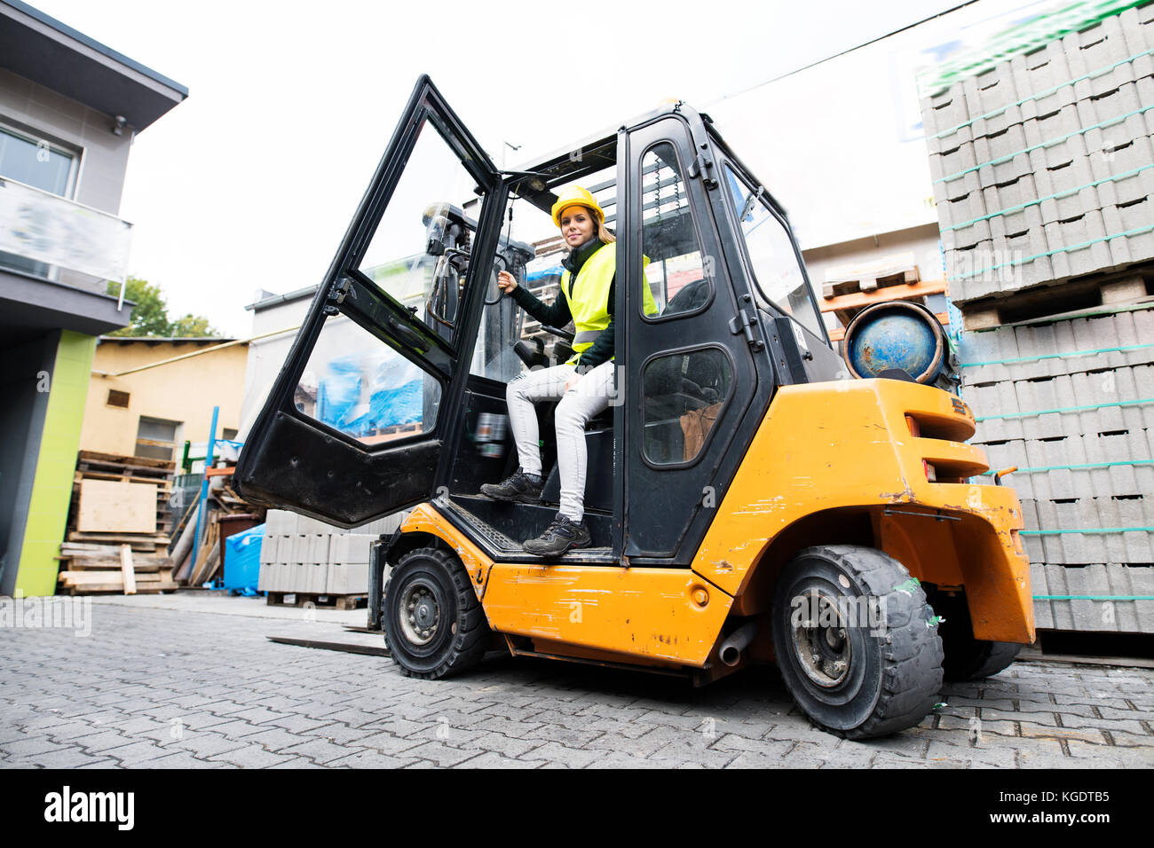 Female forklift truck driver outside a warehouse Stock Photo - Alamy