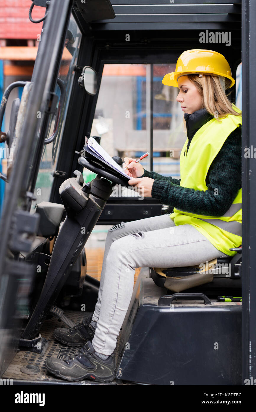 Female forklift truck driver outside a warehouse Stock Photo - Alamy