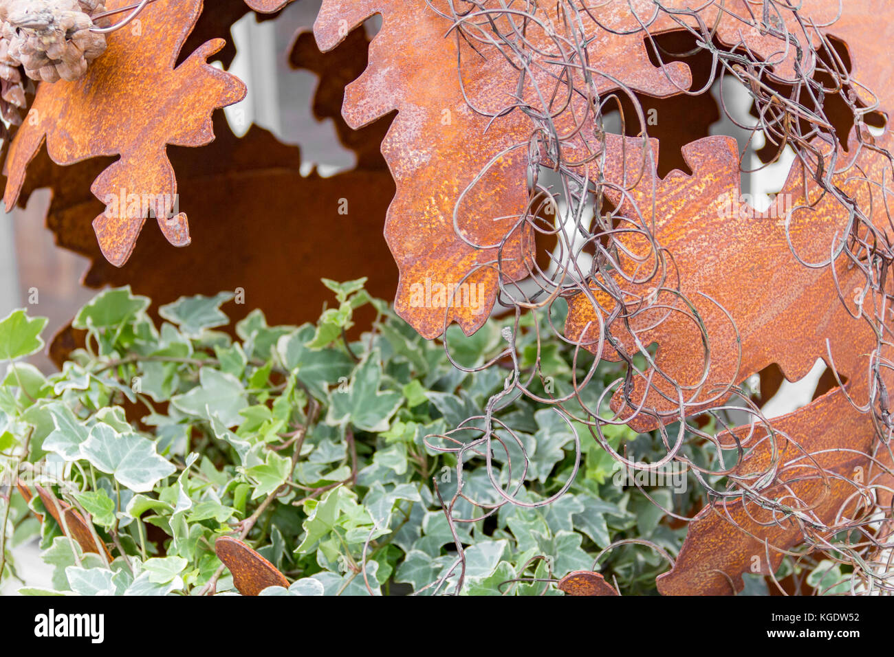 decoration detail including a fragmented rusty bowl and ivy plant Stock ...