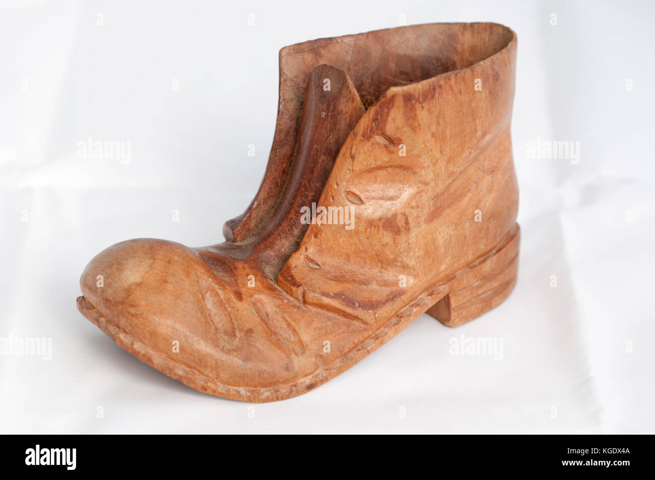 Hand crafted Wooden old boot on white background Stock Photo - Alamy