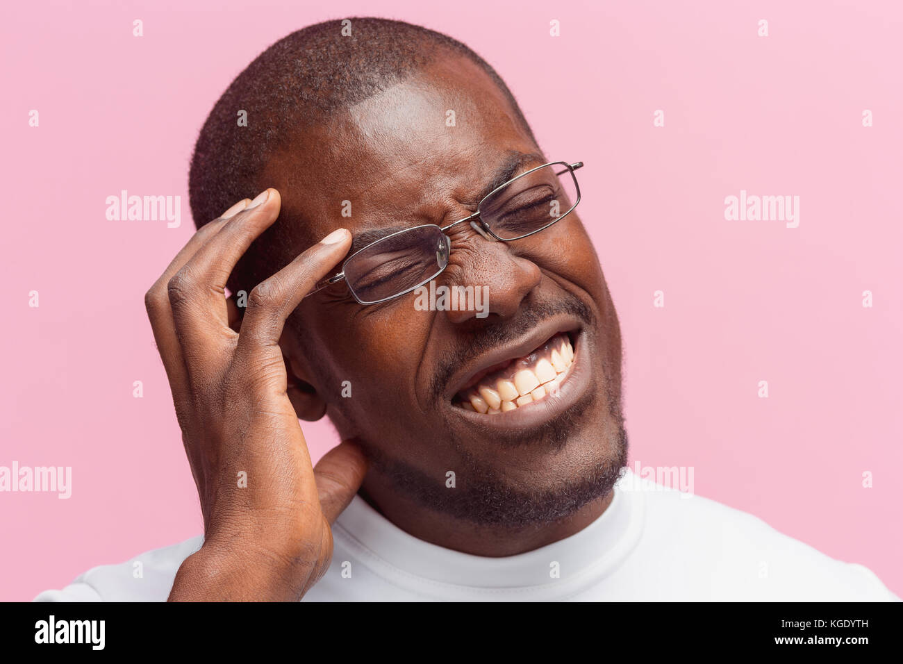 Black man holding his head in pain and depression Stock Photo - Alamy