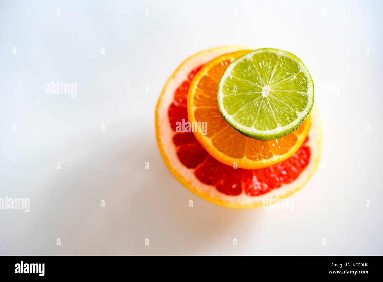 Colorful pile of half citrus fruit, top view, horizontal. Grapefruit ...