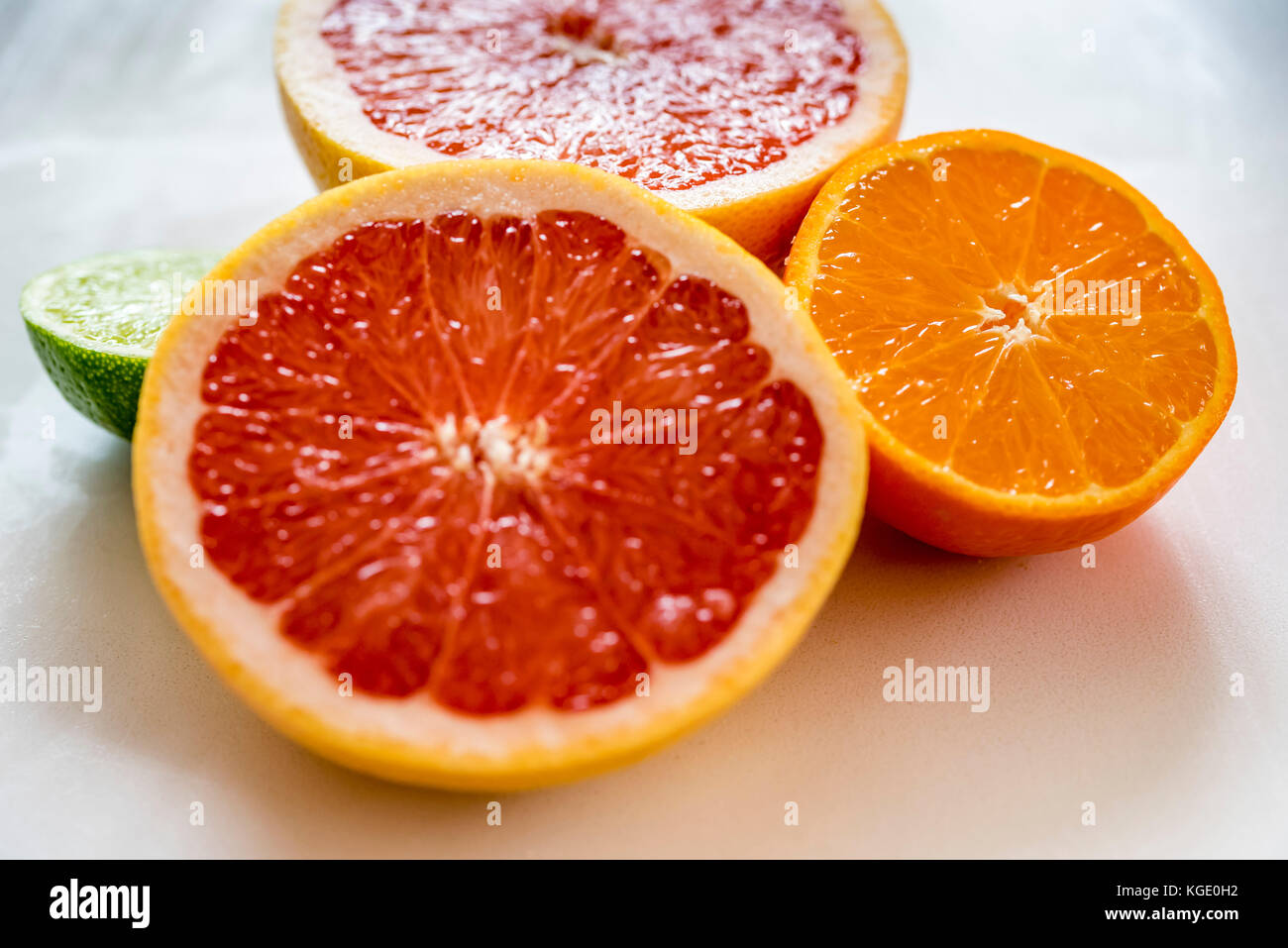 Colorful half citrus fruit, side view, closeup. Grapefruit, orange and ...