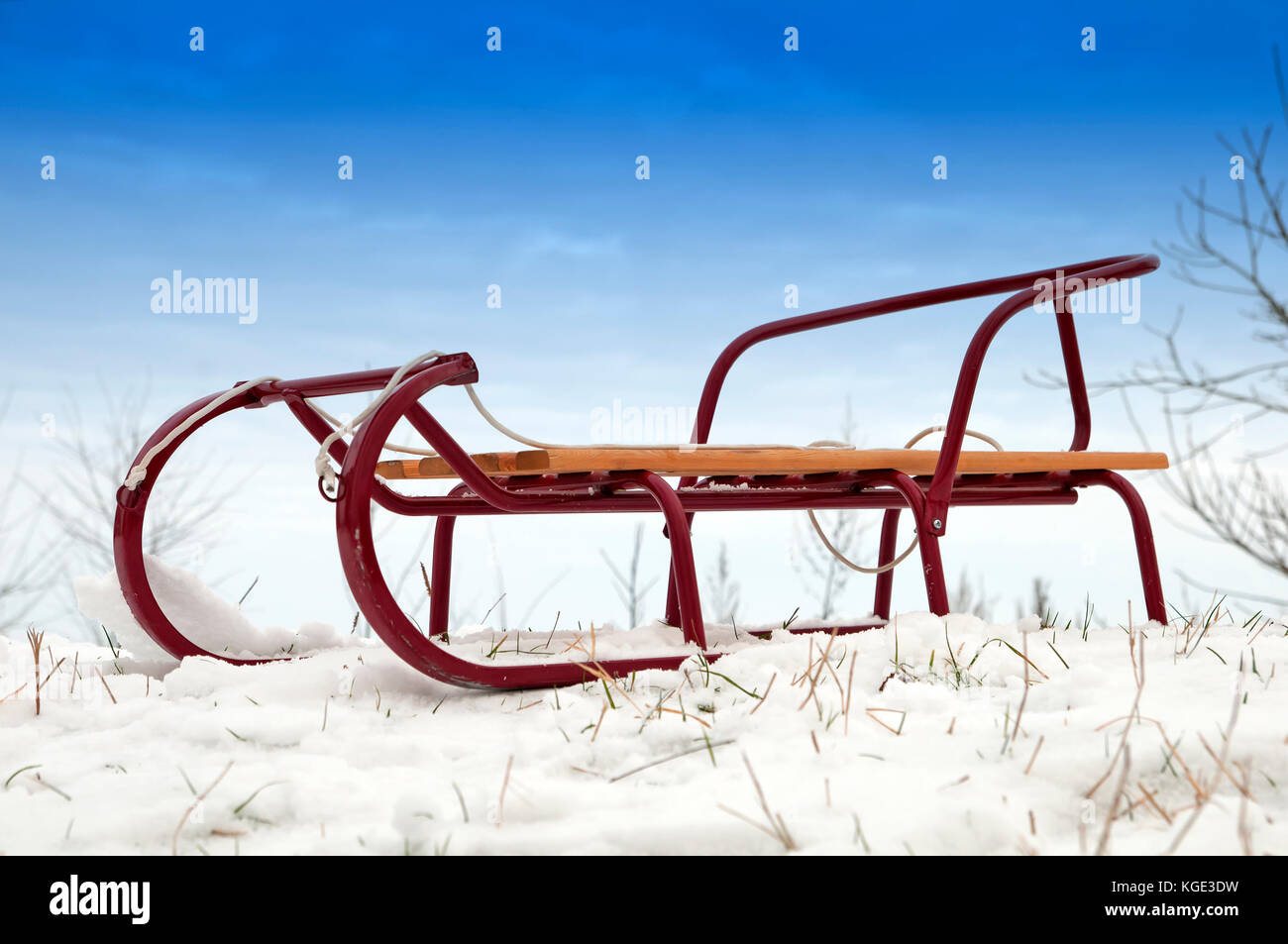 red sledge in the snow Stock Photo - Alamy