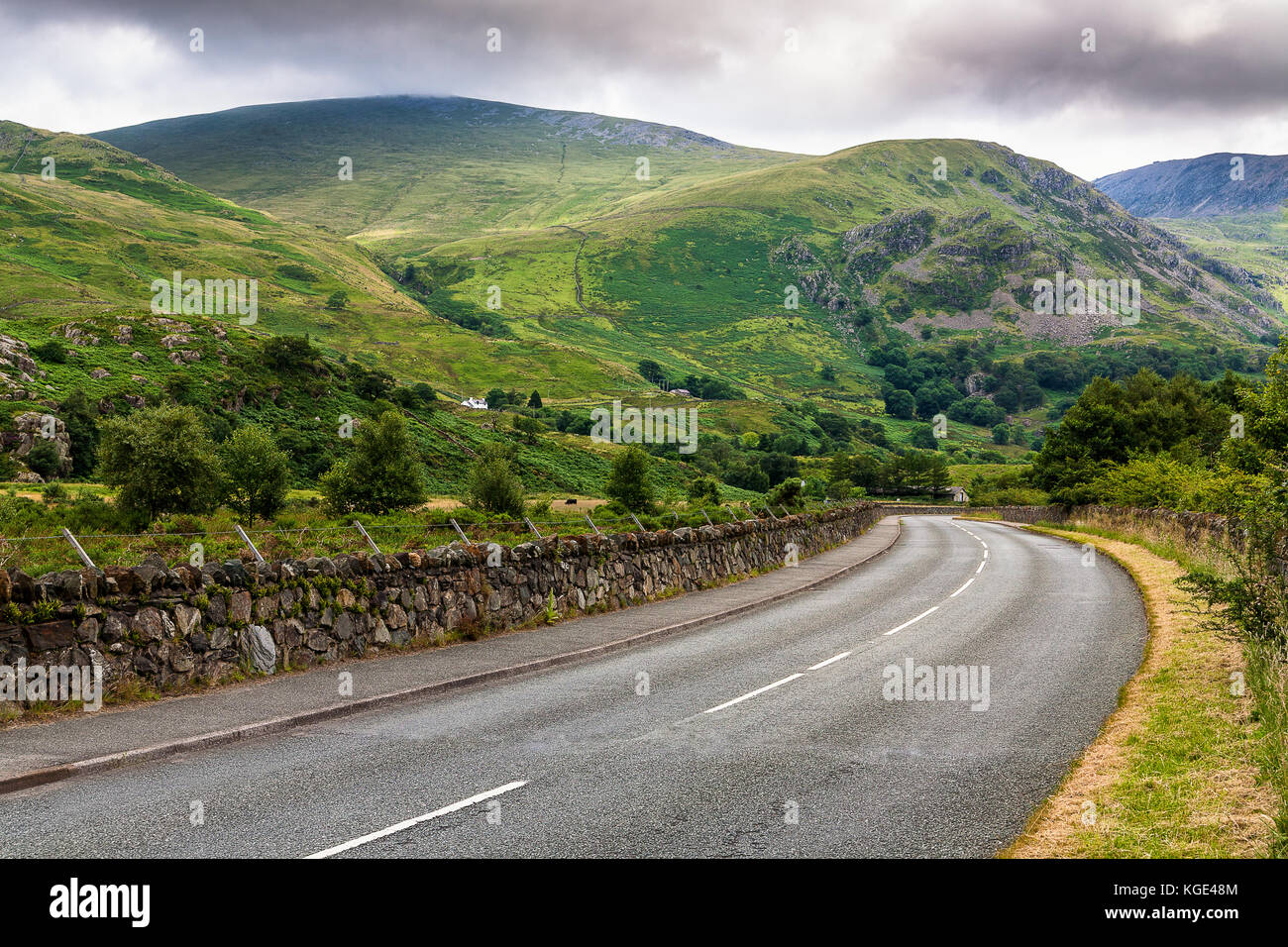 Curved road in countryside surrounded with mountains in Wales, United ...