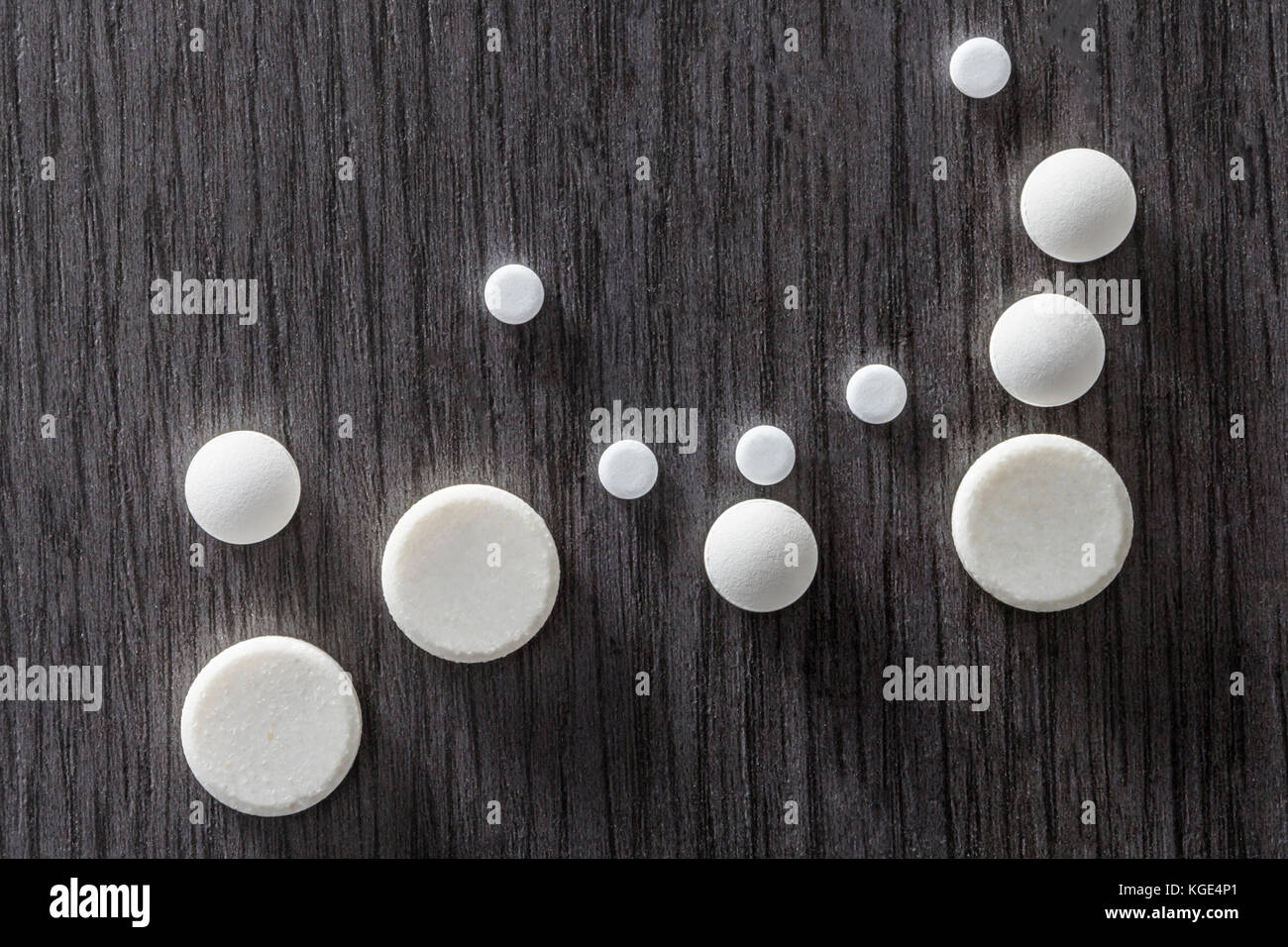 Some Round White Pills Of Different Size Stock Photo - Alamy