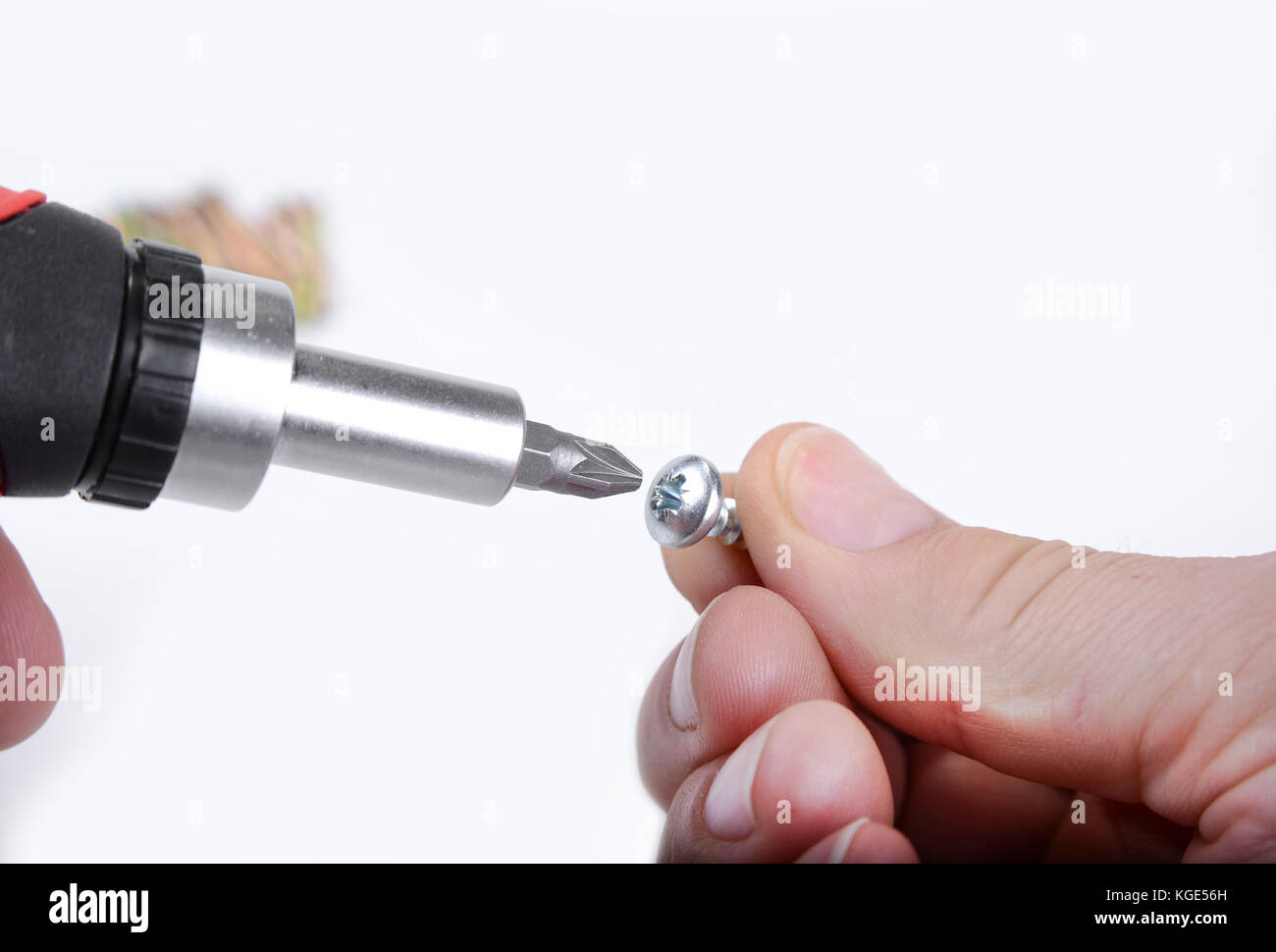 Man holding screwdriver with the screw on white background Stock Photo ...