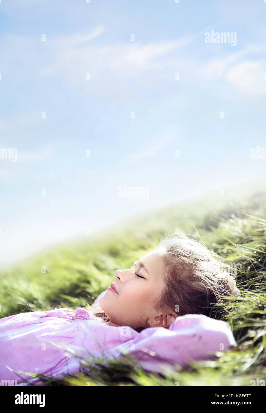 Pretty, cute girl having a nap on a fresh, summer meadow Stock Photo ...