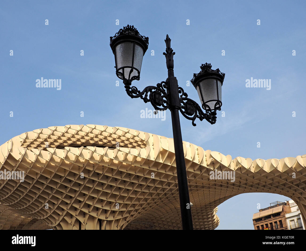 ornate city lamp-post in front of contours and shapes of part of the ...