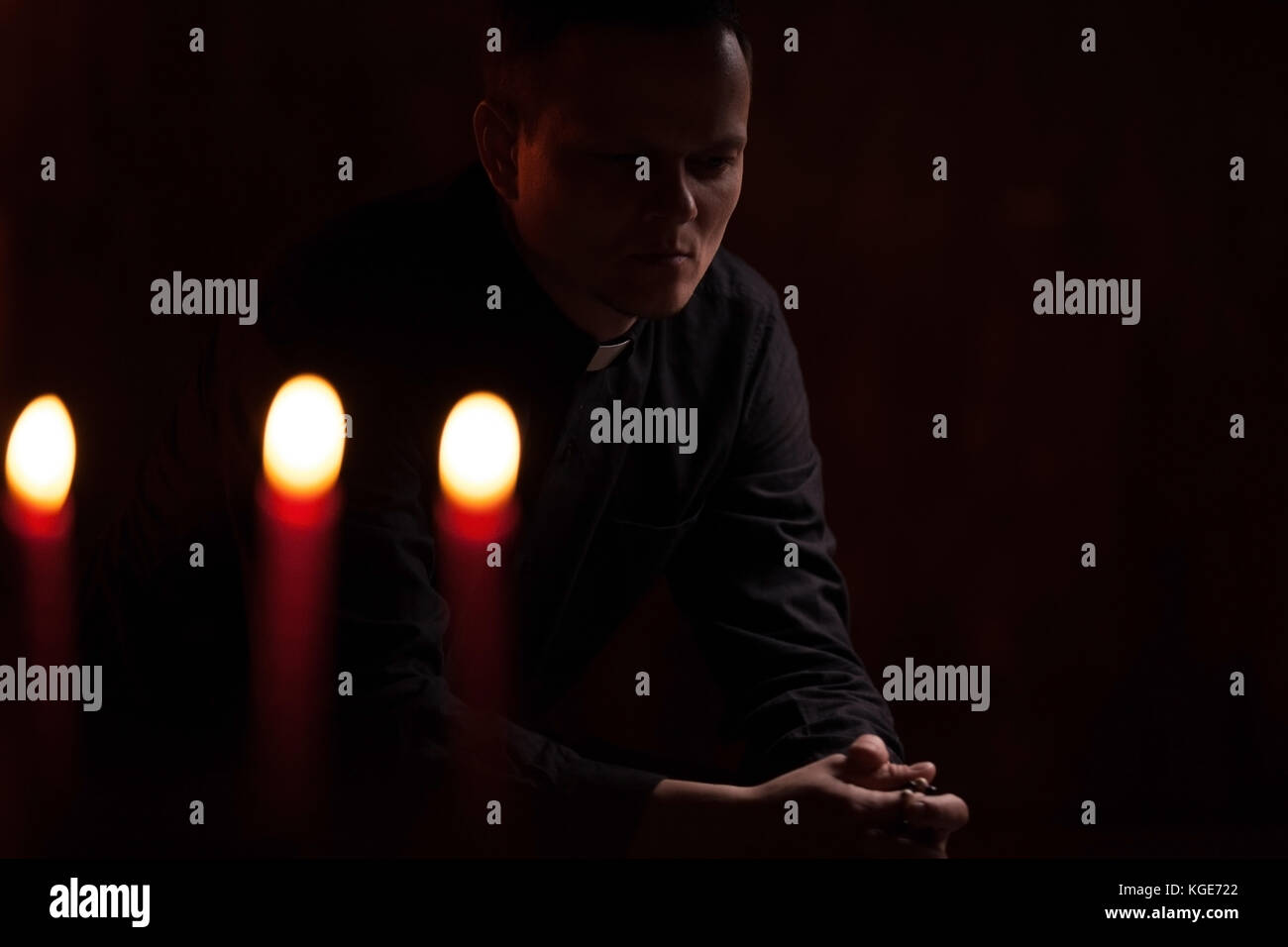 Portrait of handsome catholic priest or pastor with dog collar, dark ...
