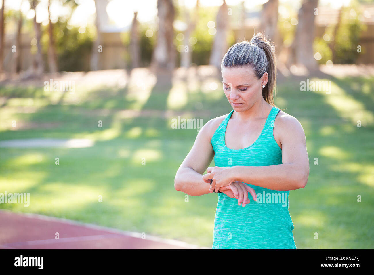 Close up wide angle view of a female sprinter athlete getting ready to ...
