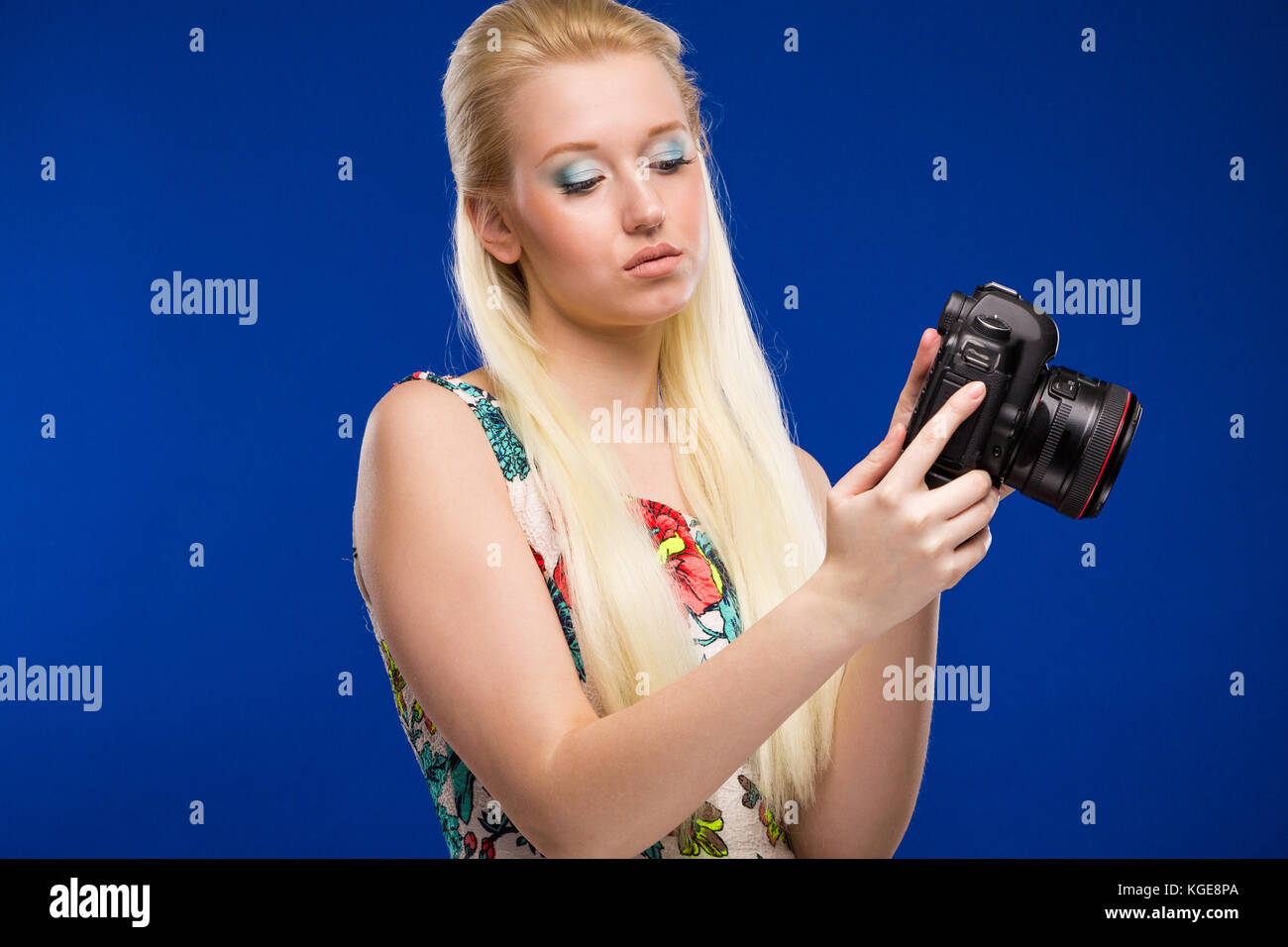 Girl with a camera in hand Stock Photo - Alamy