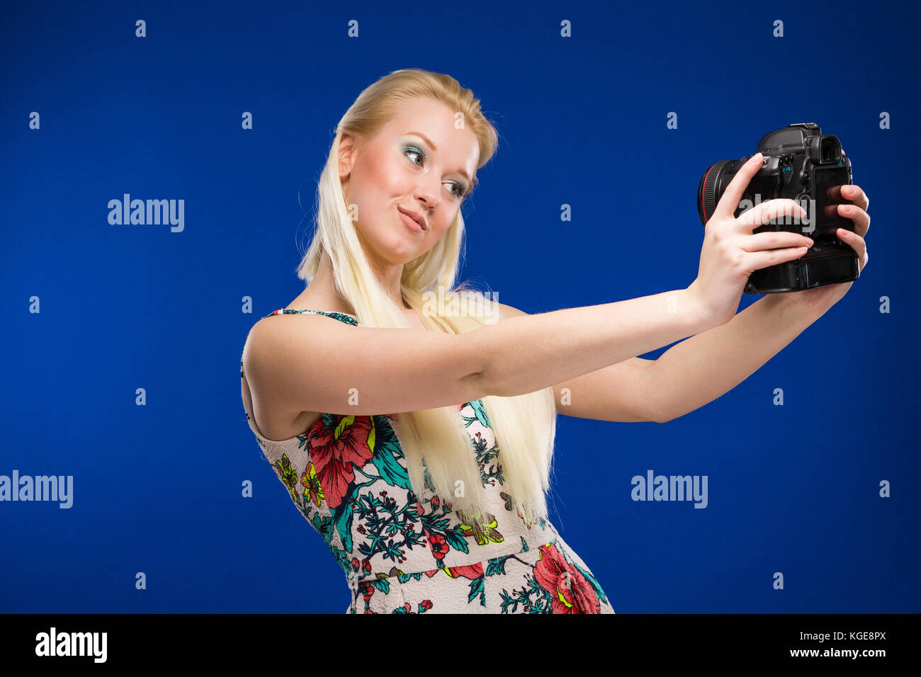 Girl with a camera in hand Stock Photo - Alamy