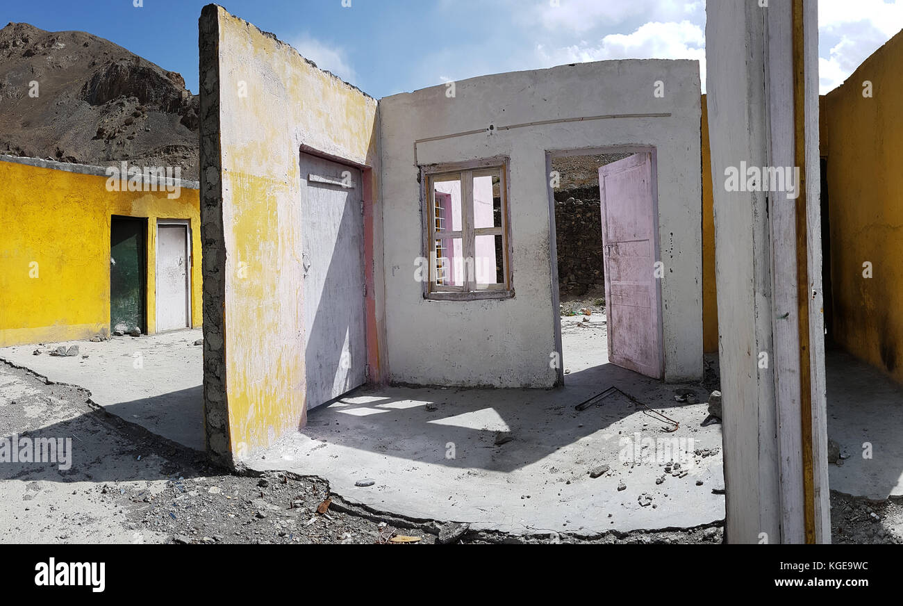 Walls of ruined house without a roof, yellow, pink and white surfaces ...